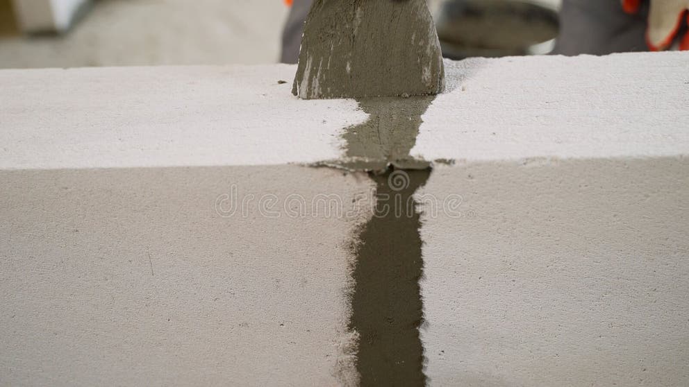 Construction Worker Applying Cement with Trowel on Aerated Concrete ...