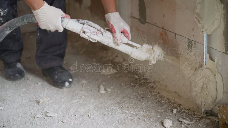 Construction Worker Applying Plaster on Ceiling with Machine Stock ...