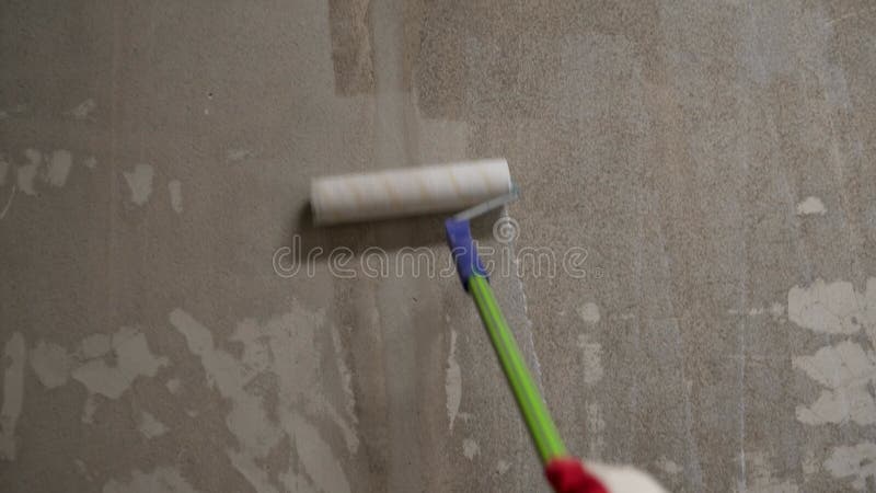 Construction Worker Applying Plaster on the Wall Using a Roller. Stock ...