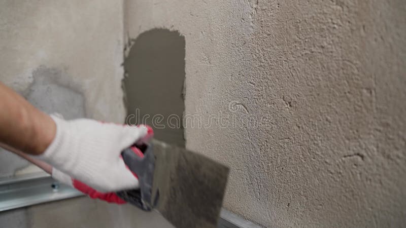 Laying Ceramic Tiles on the Wall. Construction Worker Applying Plaster ...