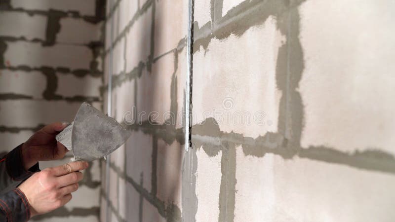 Construction Worker Applying Plaster on White Brick Wall Using Trowel ...