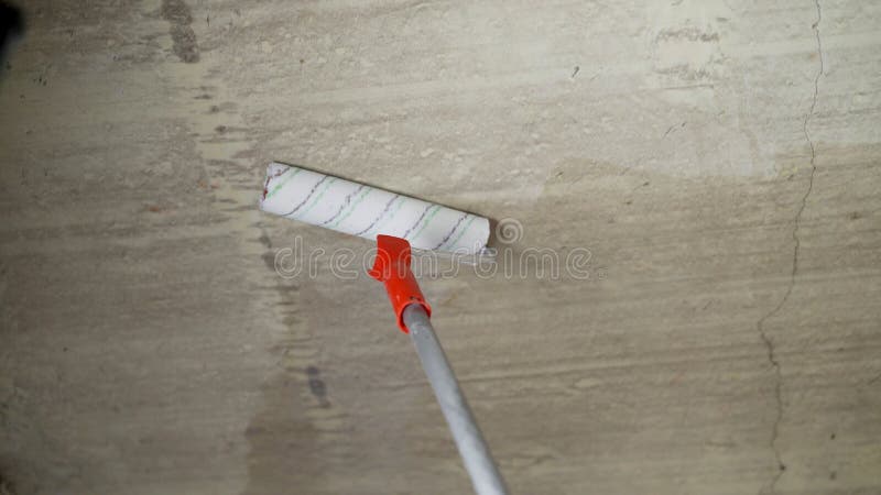 Construction Worker Applying Primer on Concrete Ceiling Using Paint ...