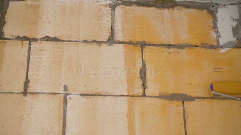 Construction Worker Painting a Cinder Block Wall Orange Stock Video ...