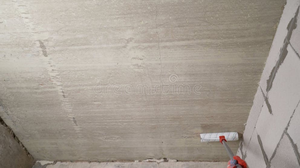 Construction Worker Applying Waterproofing Coating on Ceiling with ...