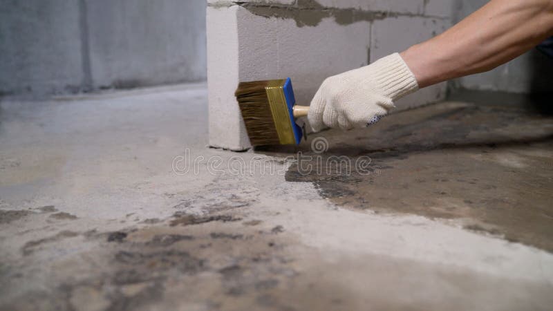 Construction Worker Applying Waterproofing Coating on Concrete Floor ...