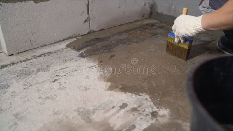 Construction Worker Applying Waterproofing Coating on Concrete Floor ...