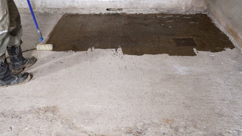 Construction Worker Applying Waterproofing Coating on Concrete Floor ...