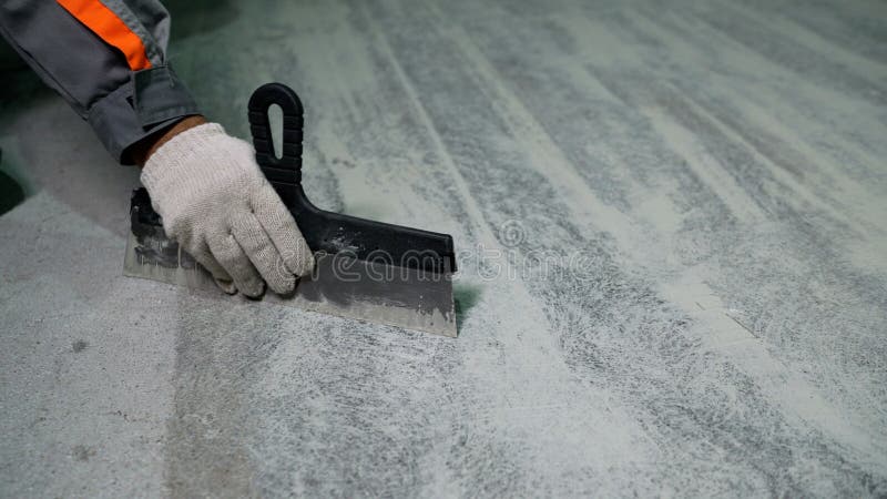 Construction Worker Applying Waterproofing Material Using a Scraper on ...