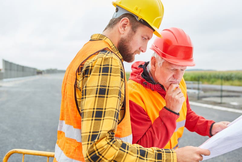 Construction Workers and Architect Look at Construction Drawing Stock ...