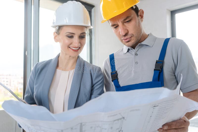 Construction Worker and Architect Looking at Plan on Site Stock Photo ...
