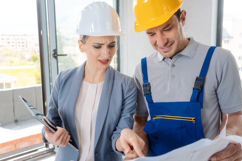 Construction Worker and Architect Looking at Plan on Site Stock Image ...