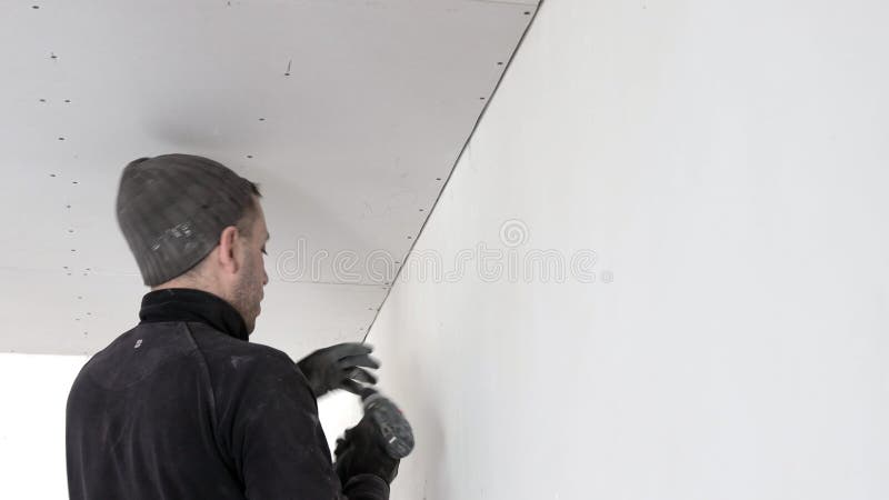 Construction Worker Assemble a Suspended Ceiling with Drywall and ...