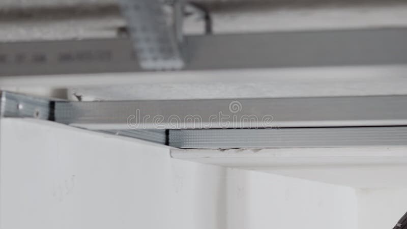 Construction Worker Assemble a Suspended Ceiling with Drywall and ...