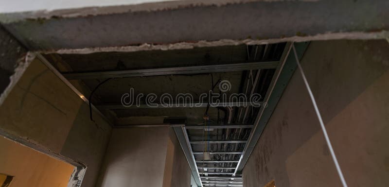 Construction Worker Assemble a Suspended Ceiling with Drywall and ...