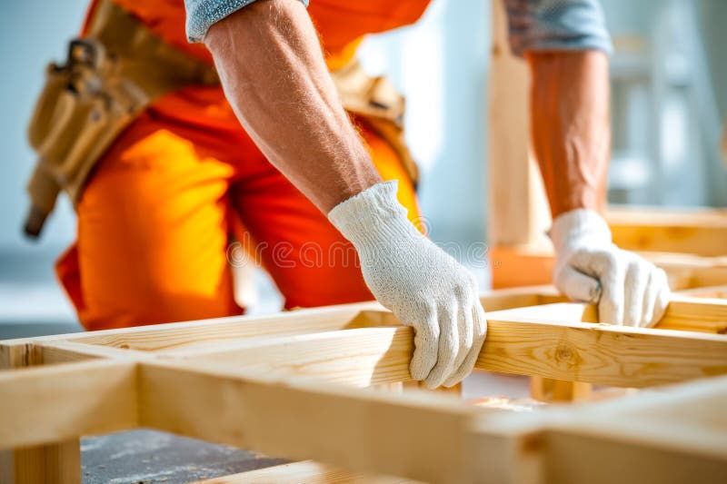 Construction Worker Assembling Wooden Framework at a Building Site ...