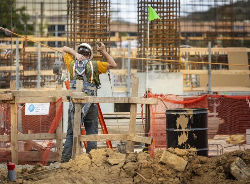 A Construction Worker Attaching Himself To a Safety Harness Editorial ...