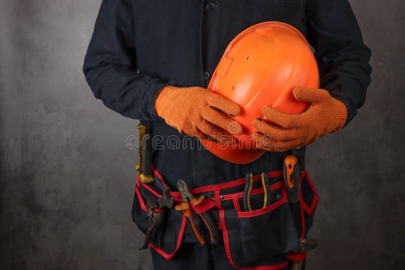 Construction Worker in a Belt with Tools and a Helmet in Hand Stock ...