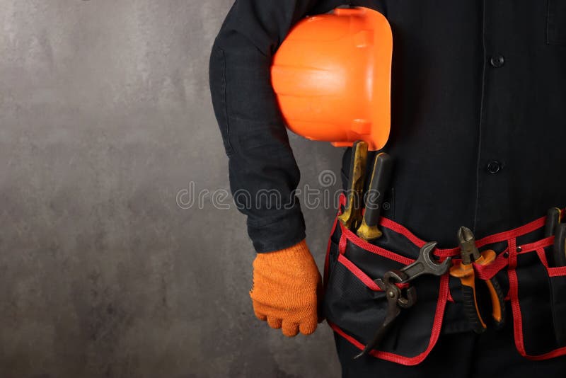 Construction Worker in a Belt with Tools and a Helmet in Hand Stock ...