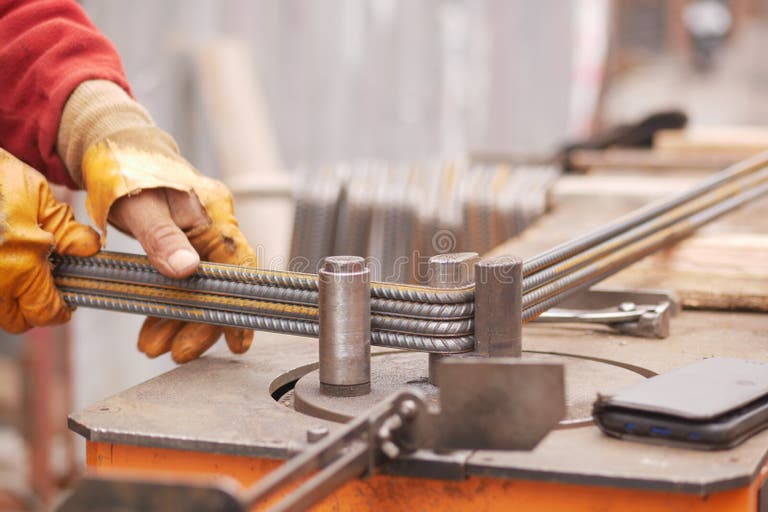 Construction Worker Bending Metal Rods at Site Stock Photo - Image of ...