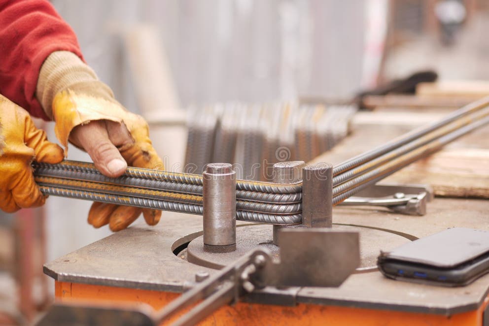 Construction Worker Bending Metal Rods at Site Stock Photo - Image of ...