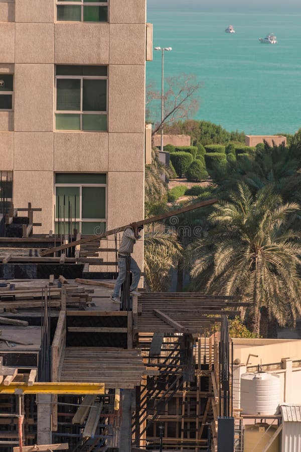 Construction Worker Bent Lifting Heavy Load on Building Site Stock ...
