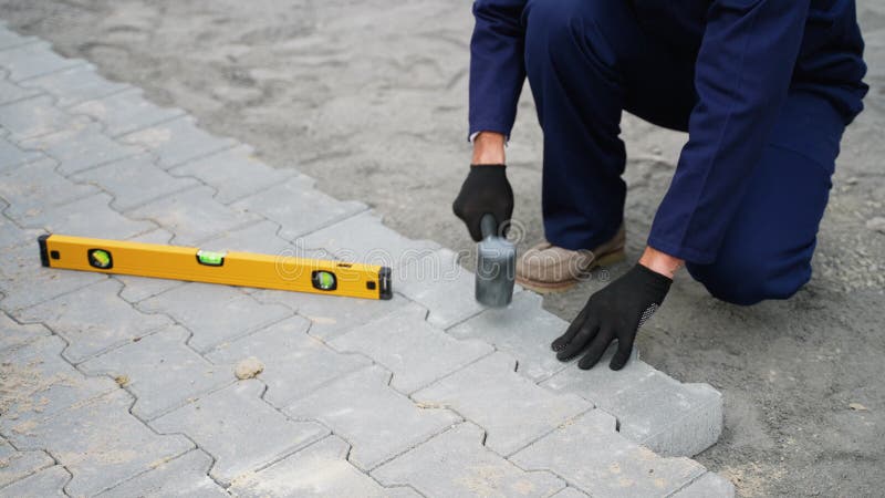 Worker Installing Paving Stones with Mallet and Level Tool Stock Video ...
