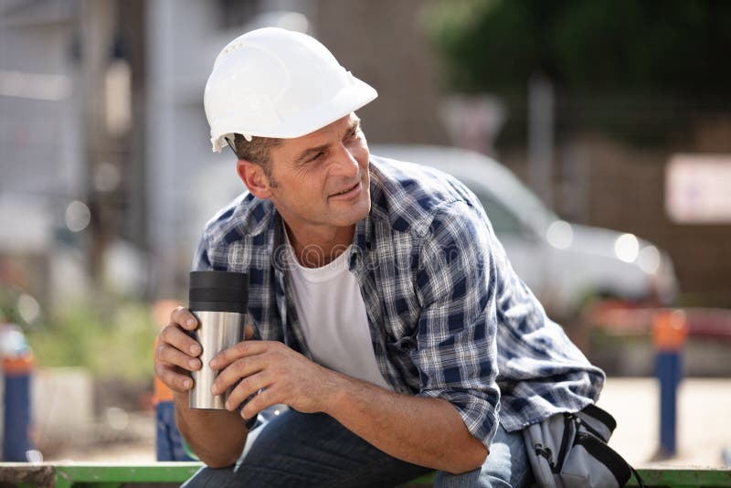 Construction Worker on Break Holding Coffee in Insulated Cup Stock ...