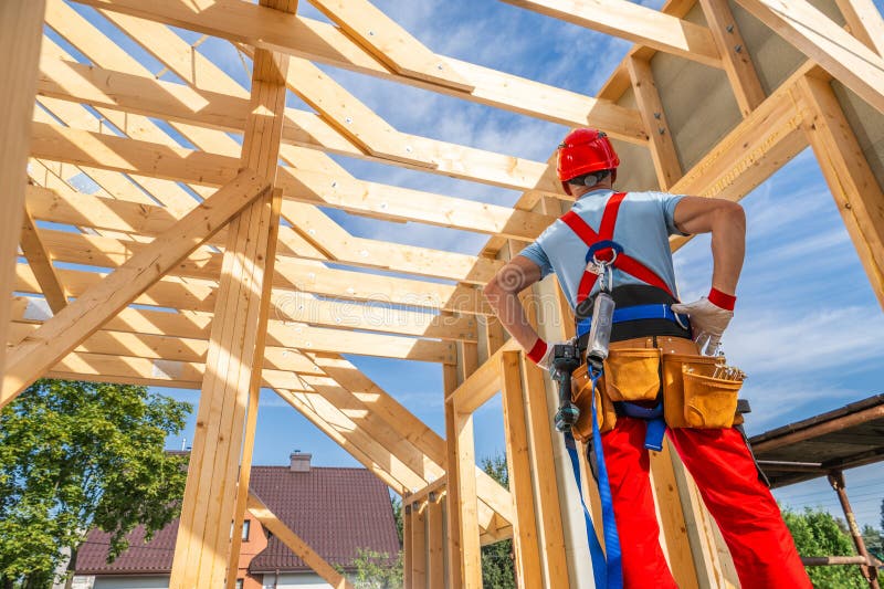 Construction Worker Observes Framing Progress of a New Residential ...