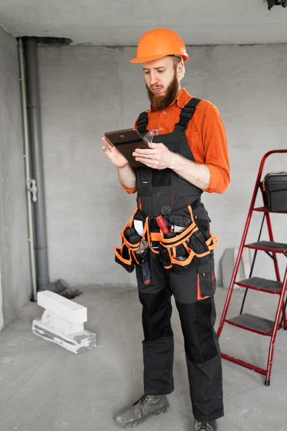 Construction Worker or Builder with Tablet in the New House Indoors ...