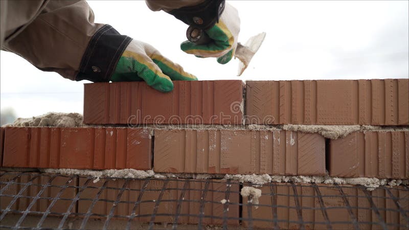 Construction Worker Building a Brick Wall with Trowel and Mortar Stock Photo - Image of wall ...