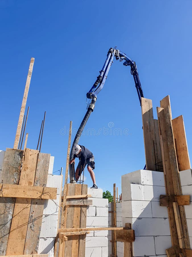 Construction Worker Building with Concrete Blocks and Pump Stock Photo ...