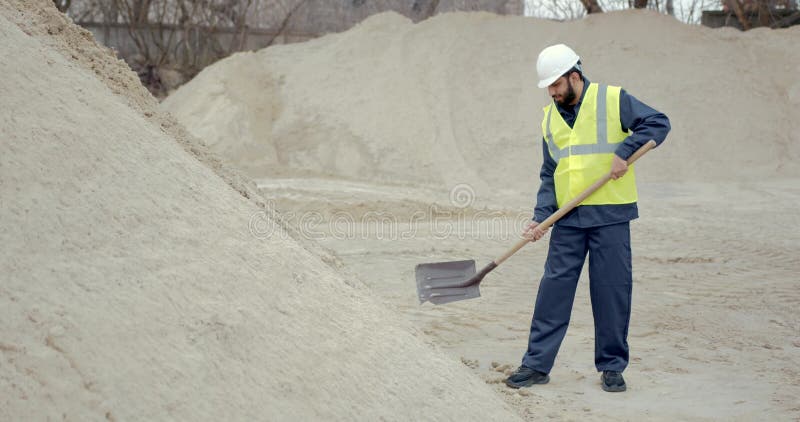 Manual Worker Digging Sand with Shovel at Building Site Stock Footage ...