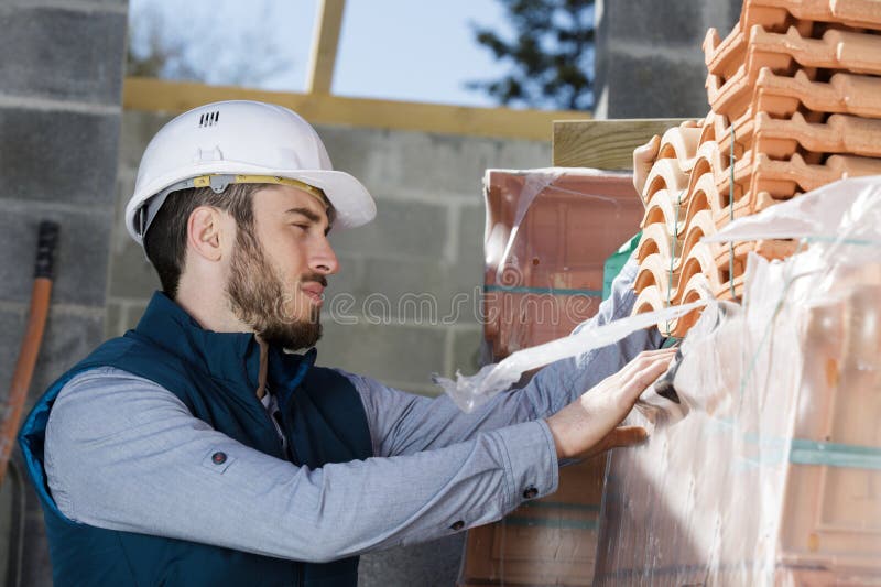 Construction Worker on Building Site Laying Slate Tiles Stock Image ...