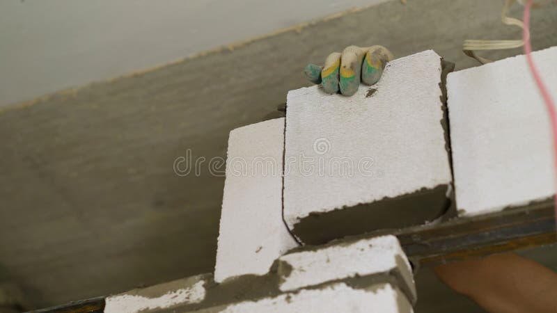 Construction Worker Building a Wall with Lightweight Concrete Blocks ...