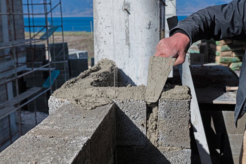 A Construction Worker Building a Wall with Mortar Stock Photo - Image ...
