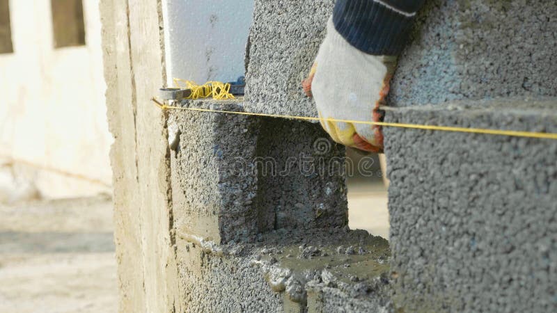 Construction Worker Builds Brick Wall, Closeup View at Construction ...