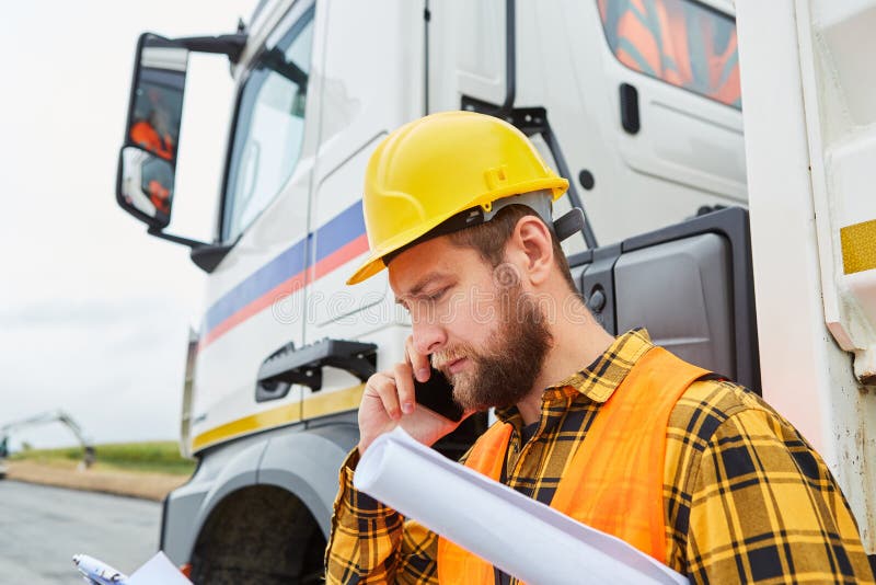 Construction Workers Talking on Mobile Phones in Front of a Truck Stock ...