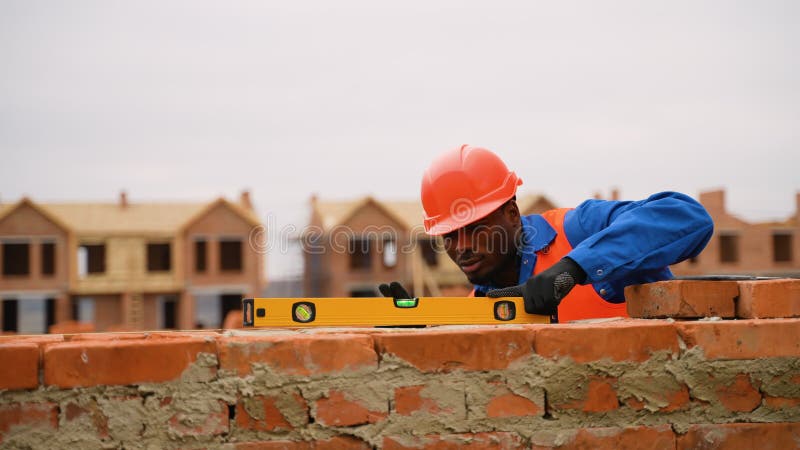 Bricklayer Checking Wall Level at Townhouse Construction Site Stock ...
