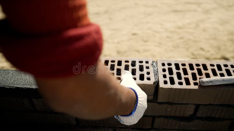 Construction Worker Building a Brick Wall Using Hammer and Chisel Stock ...