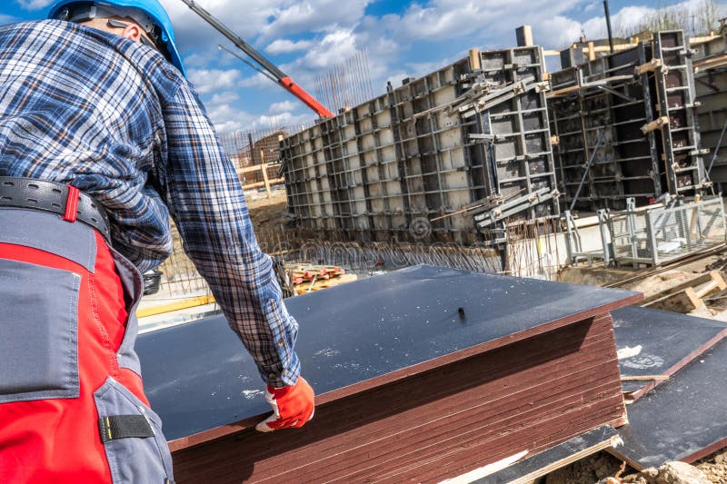 Construction Worker Handling Materials at a Building Site in Spring ...