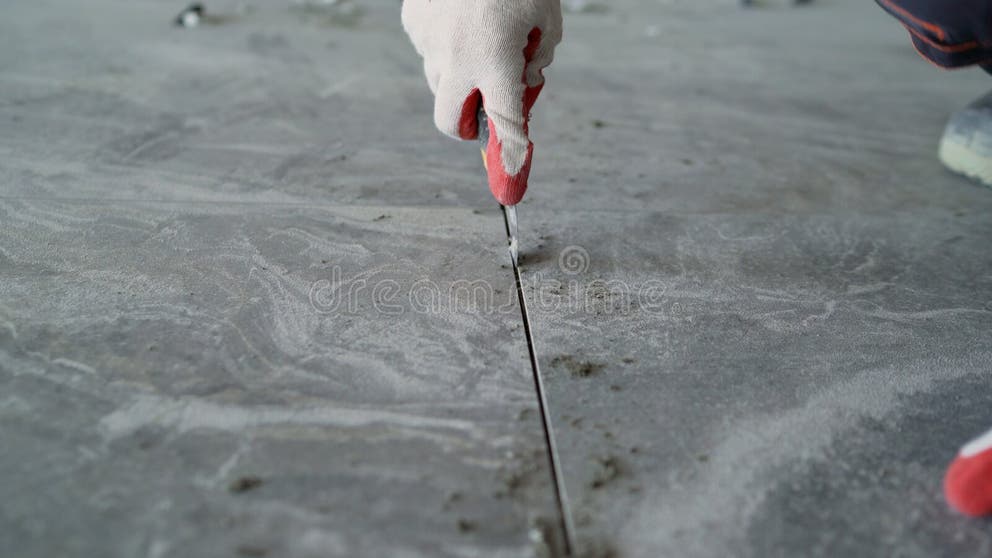Construction Worker Removing Excess Grout from Tiles Stock Photo ...