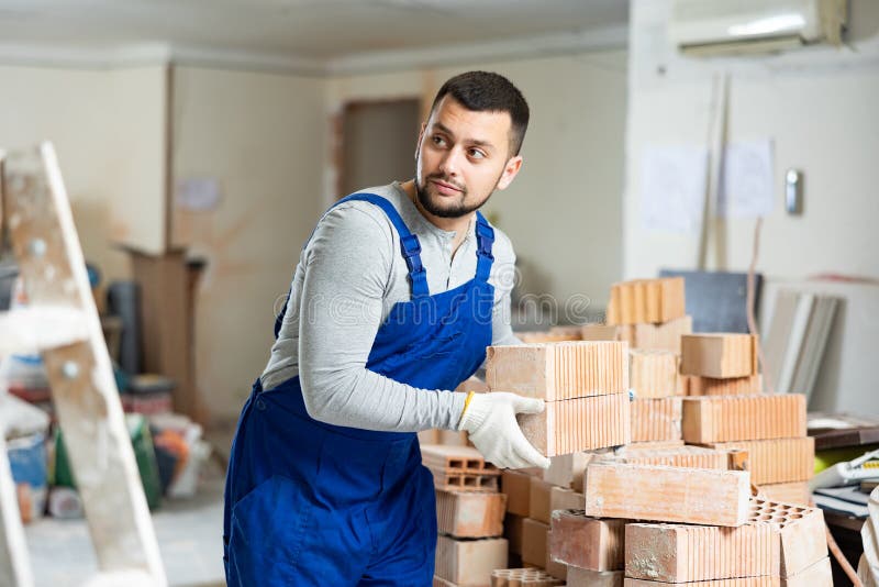 Construction Worker Carrying Bricks at Renovating Object Stock Photo ...