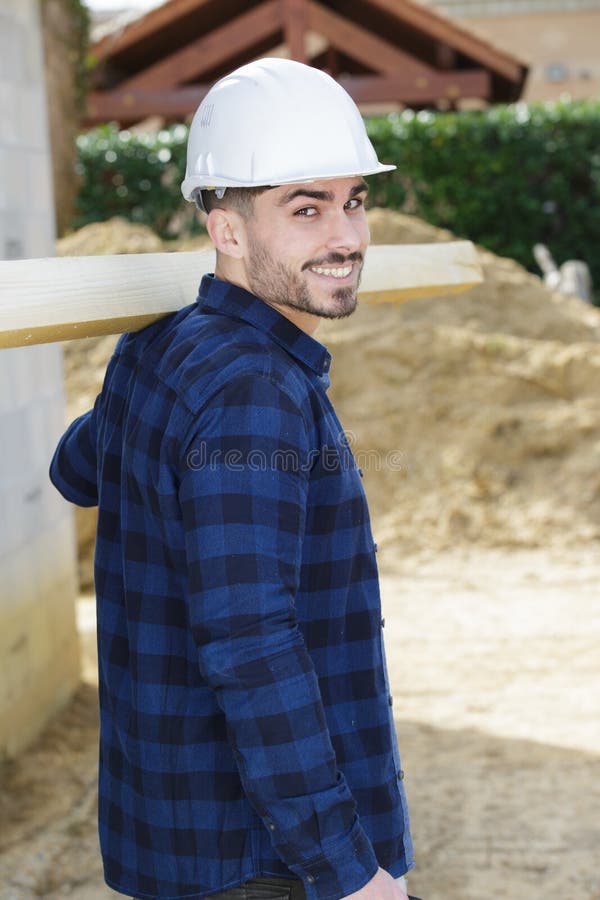 Construction Worker Carrying Wood on Shoulder Stock Photo - Image of ...