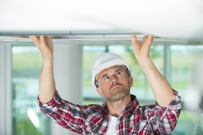Construction Worker Changing Ceiling Panel at Site Stock Photo - Image ...