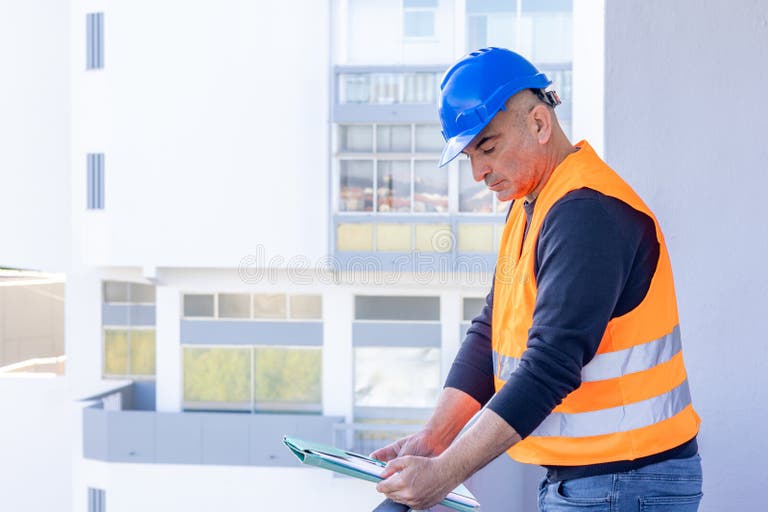 Construction Worker Checking Building Plans Stock Image - Image of reading, work: 353984885