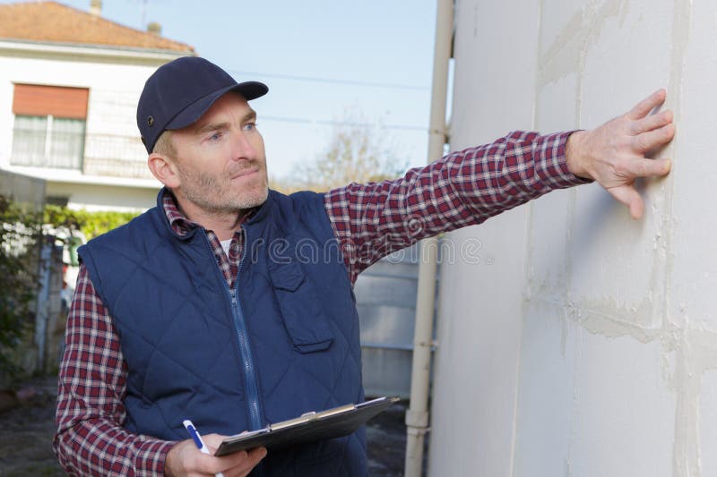 Construction Worker Checking House Wall Stock Image - Image of wall ...