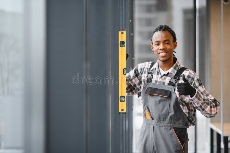 Construction Worker Checking Vertical Alignment with Spirit Level and ...
