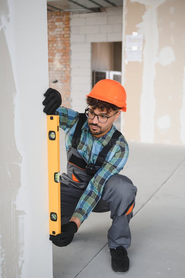 Construction Worker Checking Wall Straightness with Spirit Level Stock ...
