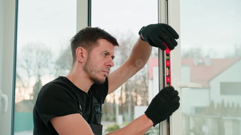 Construction Worker Checking Window Level with Spirit Level during ...