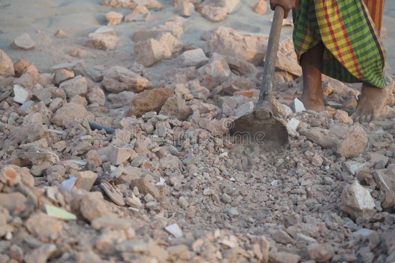 Construction Worker Clearing Rubble at a Site in Daylight Stock Photo ...